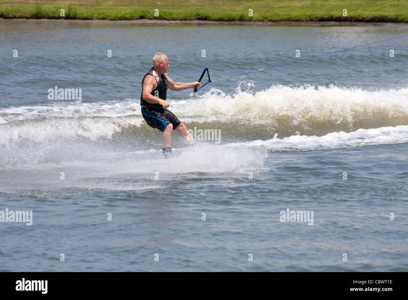 Man jumping the wake, stunts on a wakeboard, extreme sport Stock Photo ...