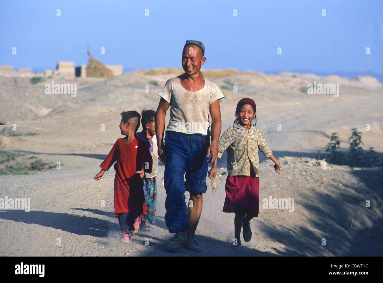 Uyghur man and children Gaochang Xinjiang China Stock Photo - Alamy