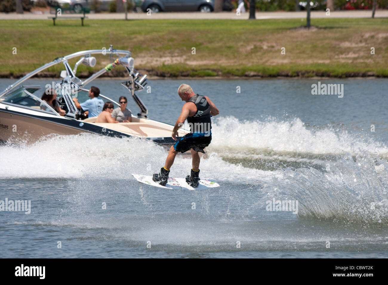 Man jumping the wake, stunts on a wakeboard, extreme sport Stock Photo ...