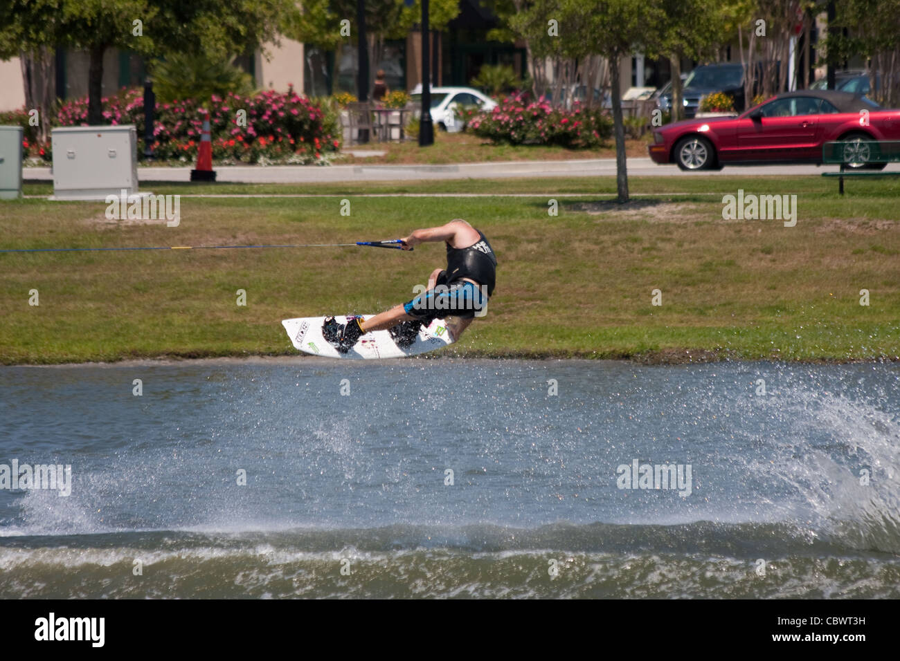 Man jumping the wake, stunts on a wakeboard, extreme sport Stock Photo ...