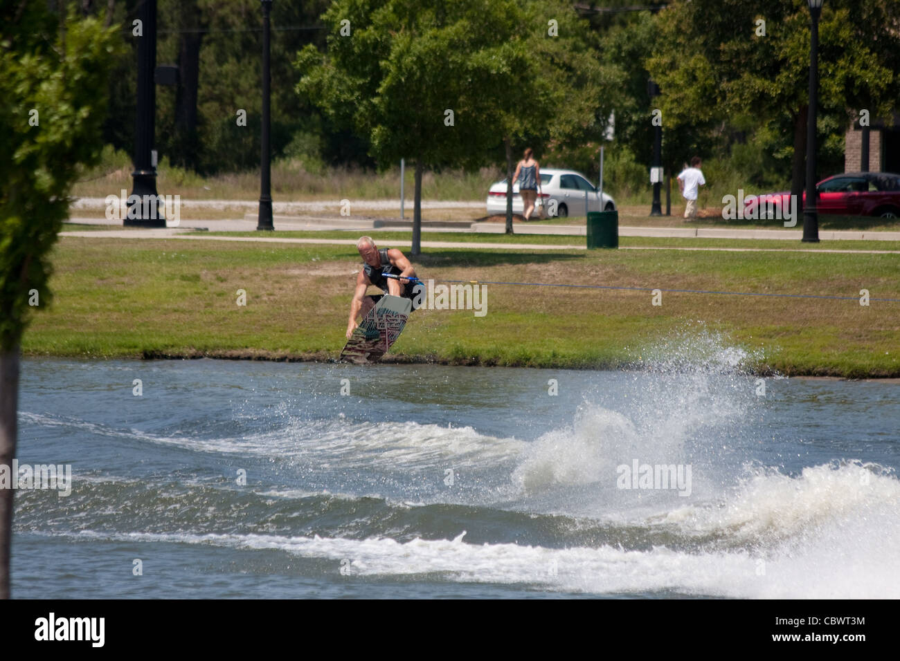 Man jumping the wake, stunts on a wakeboard, extreme sport Stock Photo ...