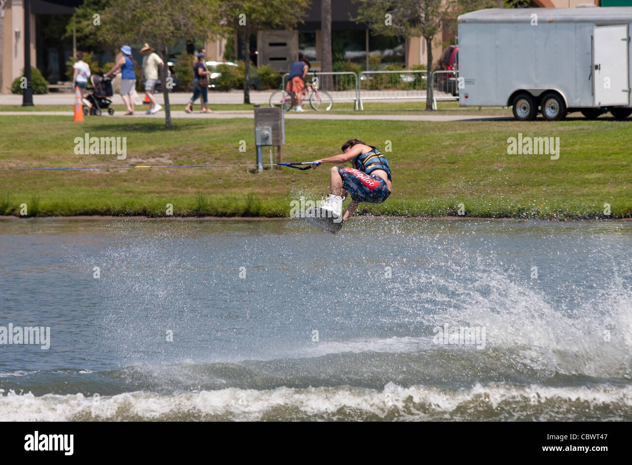 Man jumping the wake, stunts on a wakeboard, extreme sport Stock Photo ...