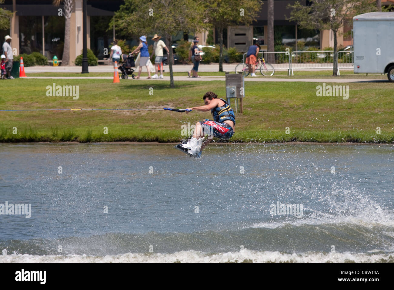 Man jumping the wake, stunts on a wakeboard, extreme sport Stock Photo ...