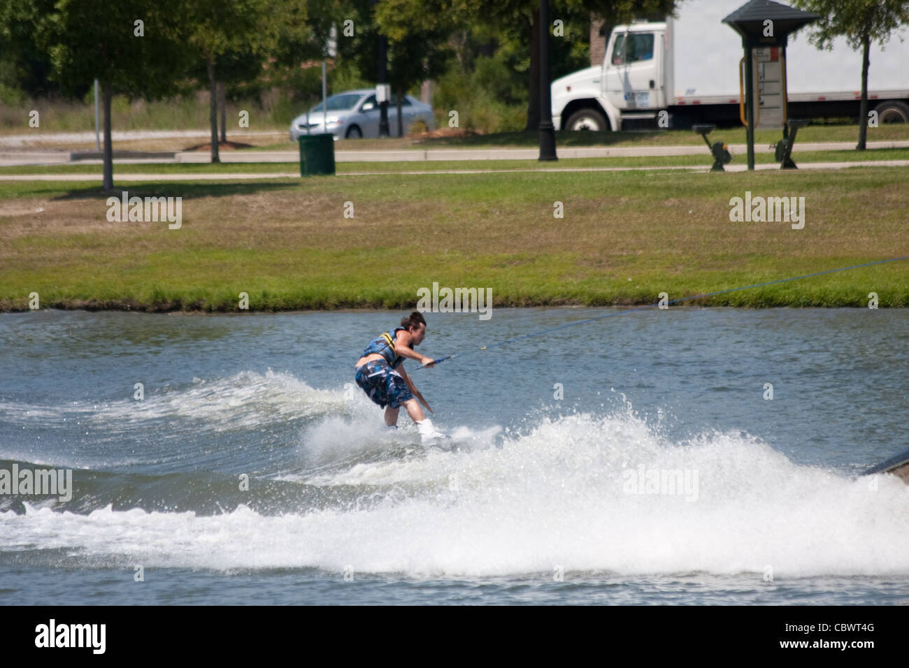 Man jumping the wake, stunts on a wakeboard, extreme sport Stock Photo ...