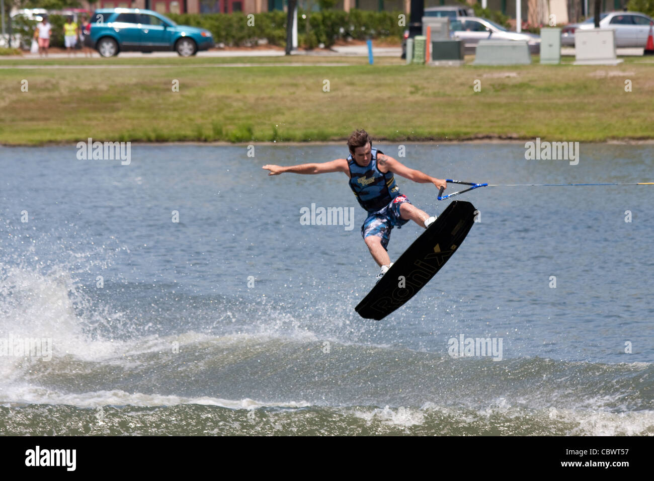 Man jumping the wake, stunts on a wakeboard, extreme sport Stock Photo ...