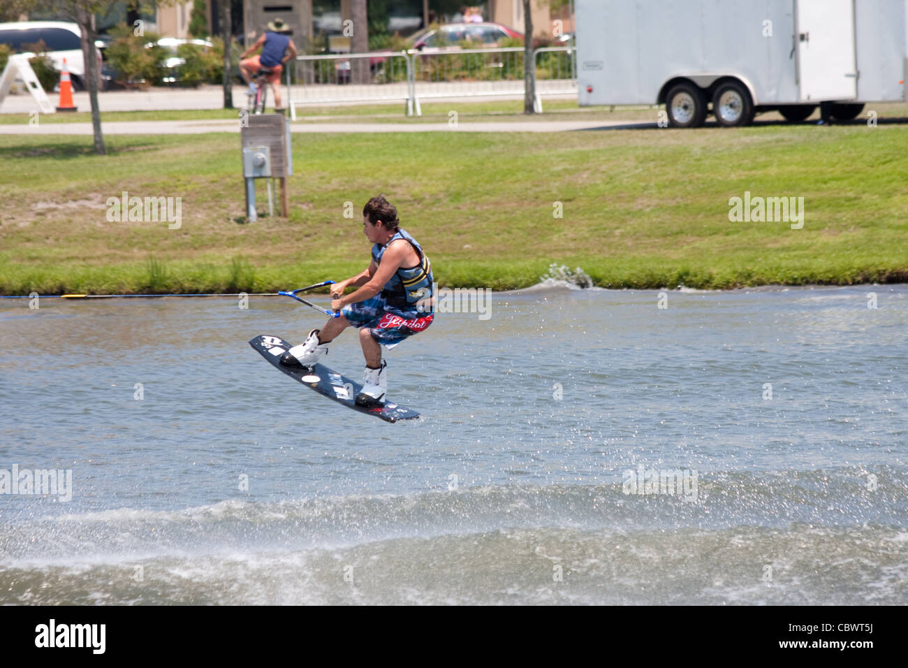 Man jumping the wake, stunts on a wakeboard, extreme sport Stock Photo ...