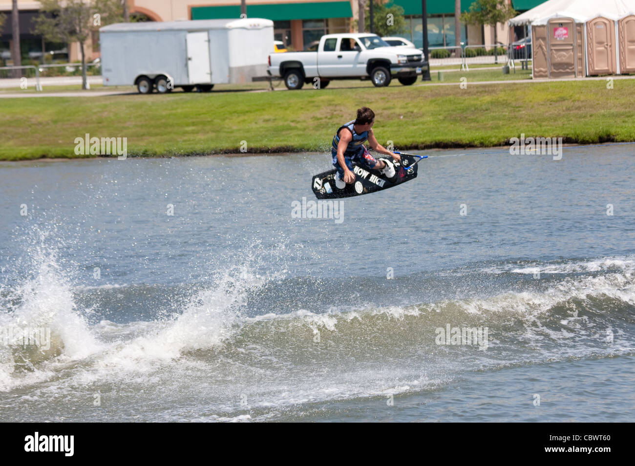 Man jumping the wake, stunts on a wakeboard, extreme sport Stock Photo ...