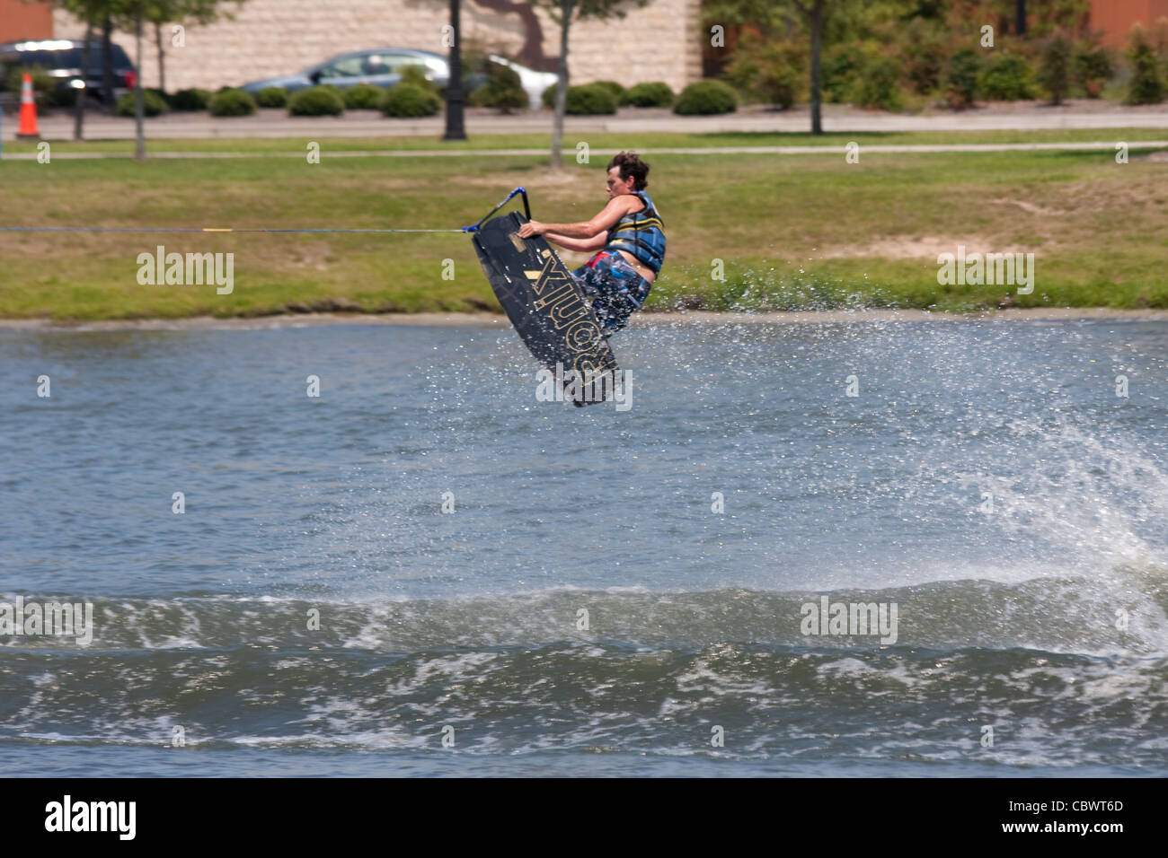 Man jumping the wake, stunts on a wakeboard, extreme sport Stock Photo ...