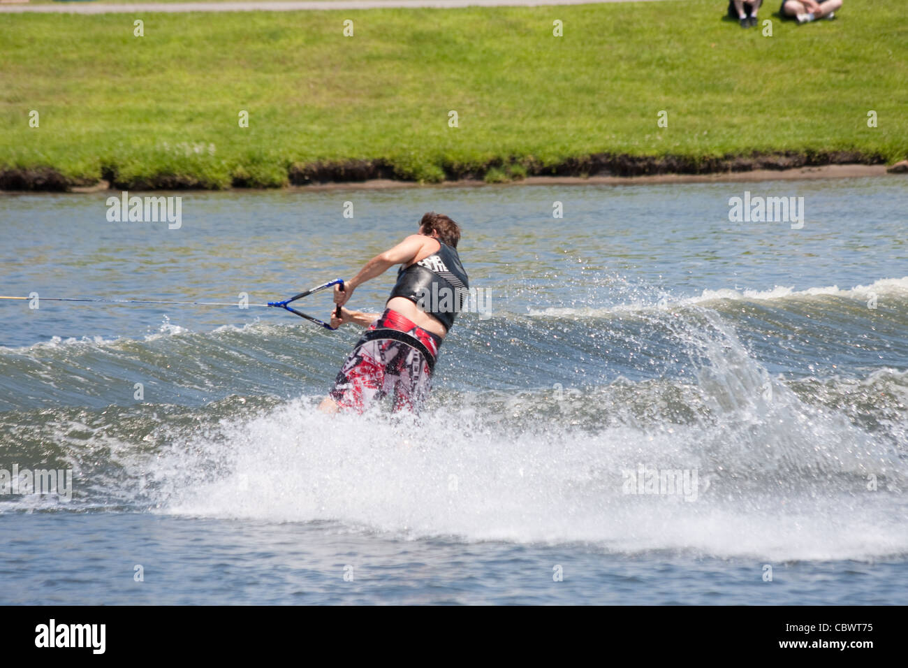 Man jumping the wake, stunts on a wakeboard, extreme sport Stock Photo ...