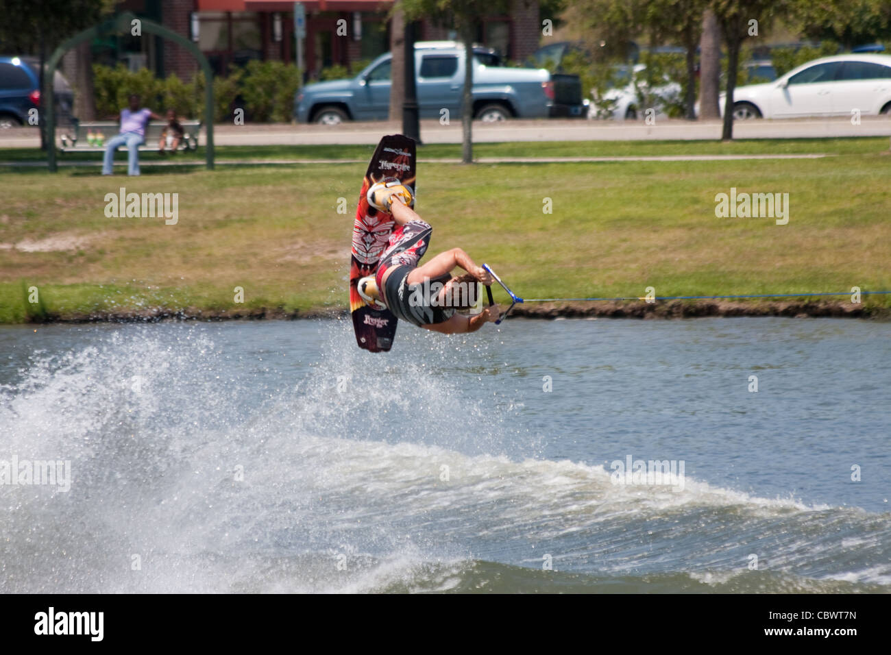 Man jumping the wake, stunts on a wakeboard, extreme sport Stock Photo ...