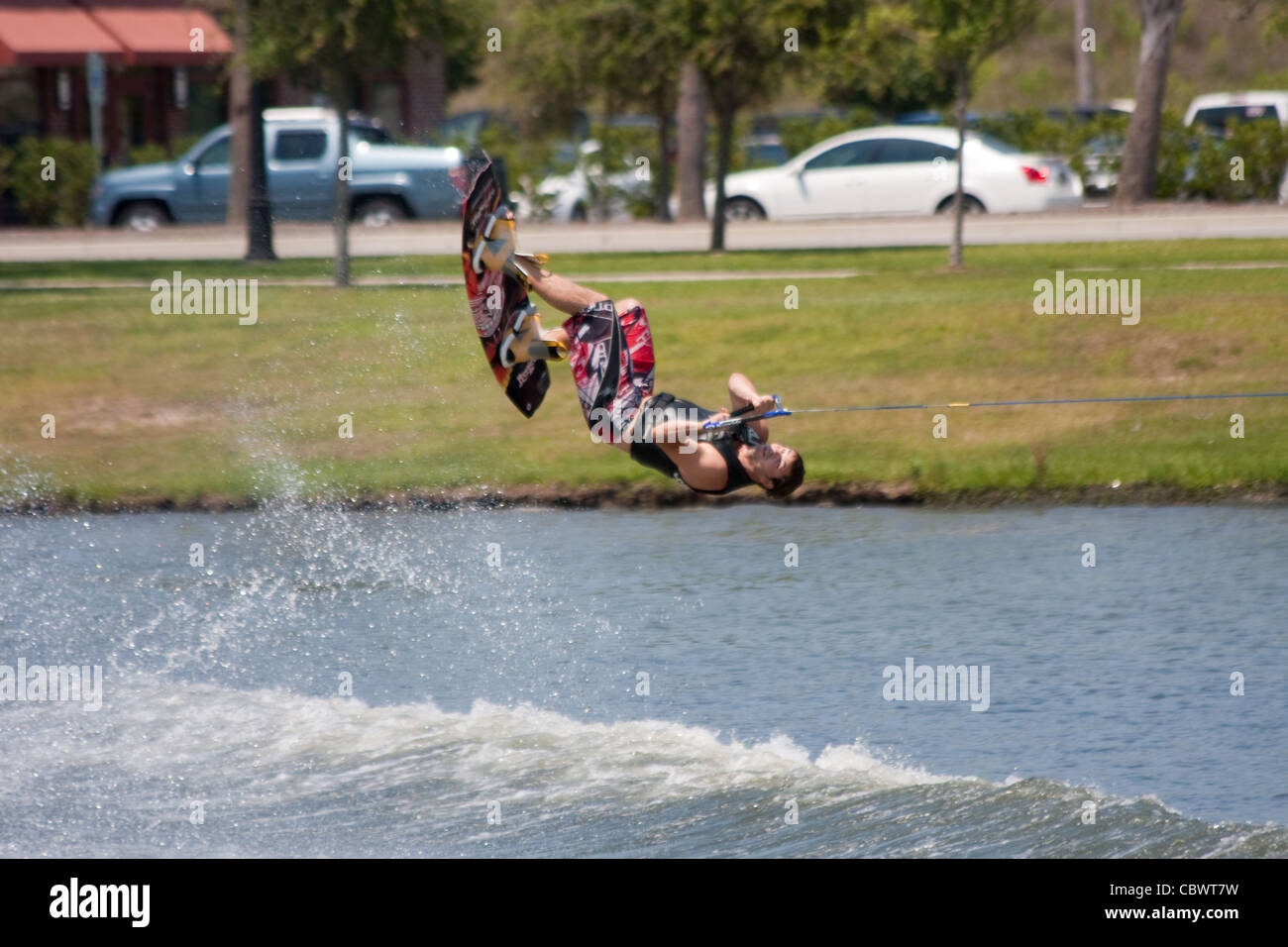 Man jumping the wake, stunts on a wakeboard, extreme sport Stock Photo ...