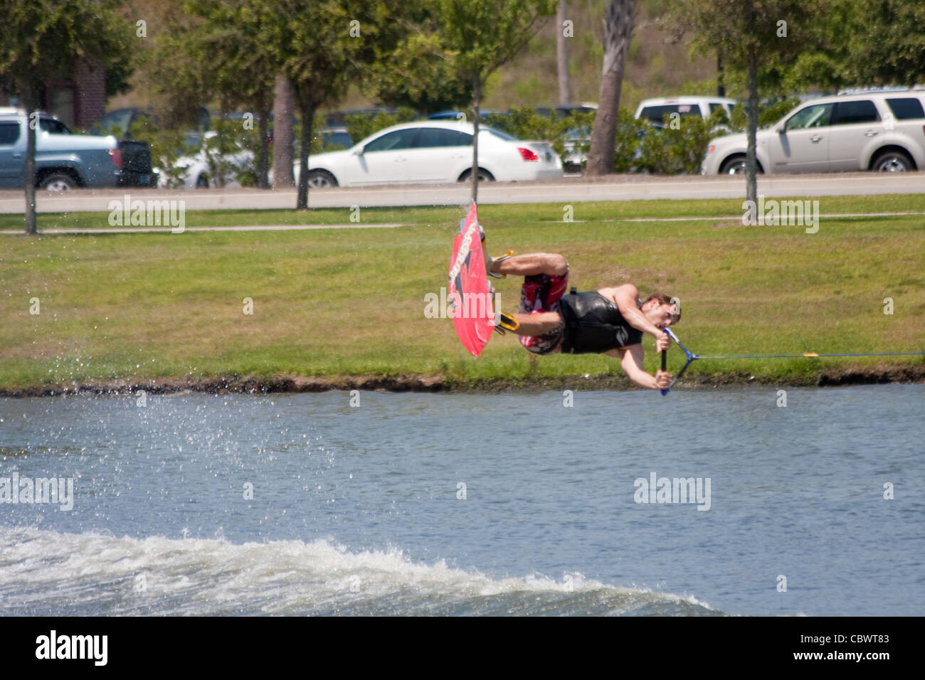 Man jumping the wake, stunts on a wakeboard, extreme sport Stock Photo ...