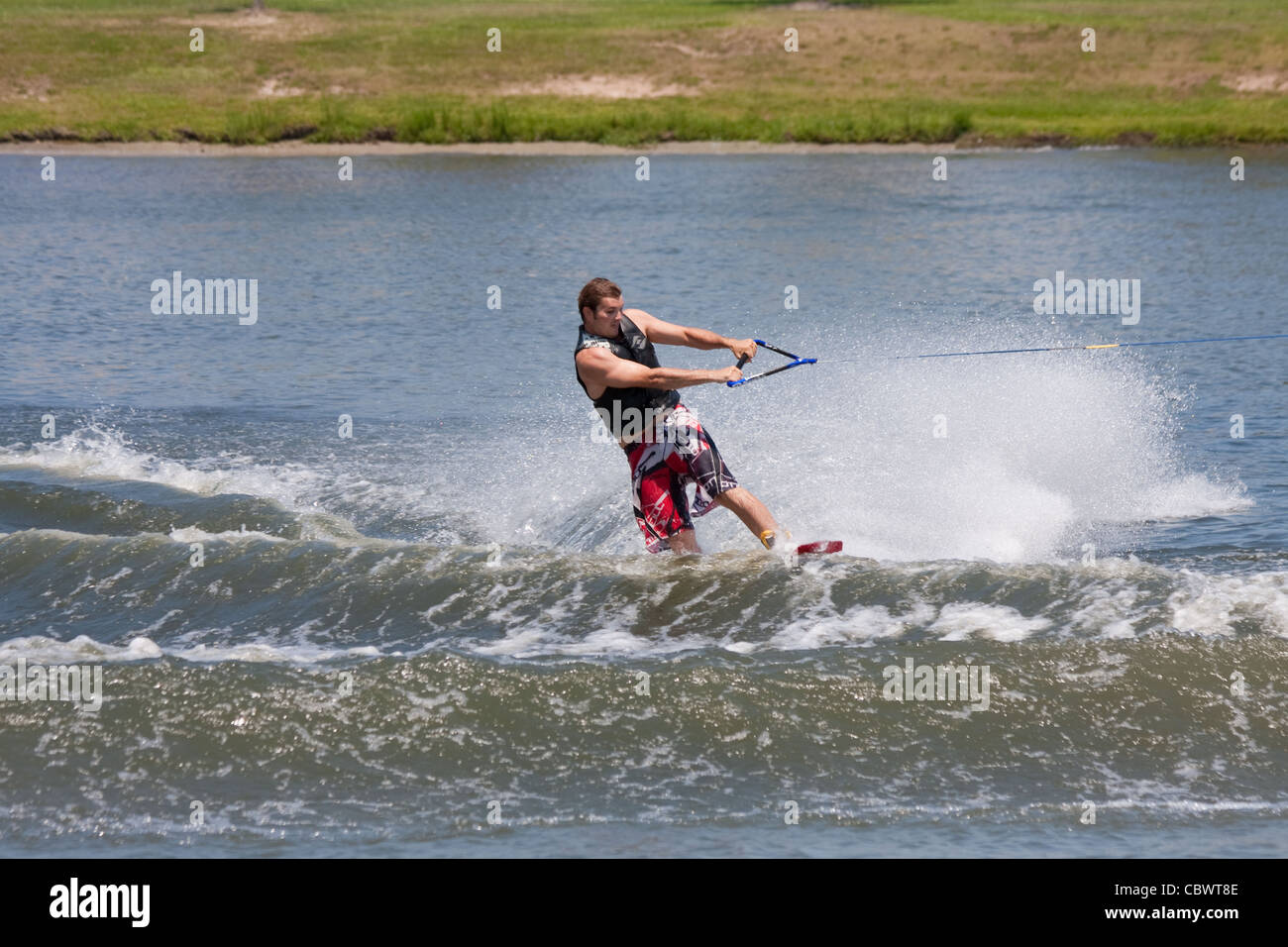 Man jumping the wake, stunts on a wakeboard, extreme sport Stock Photo ...
