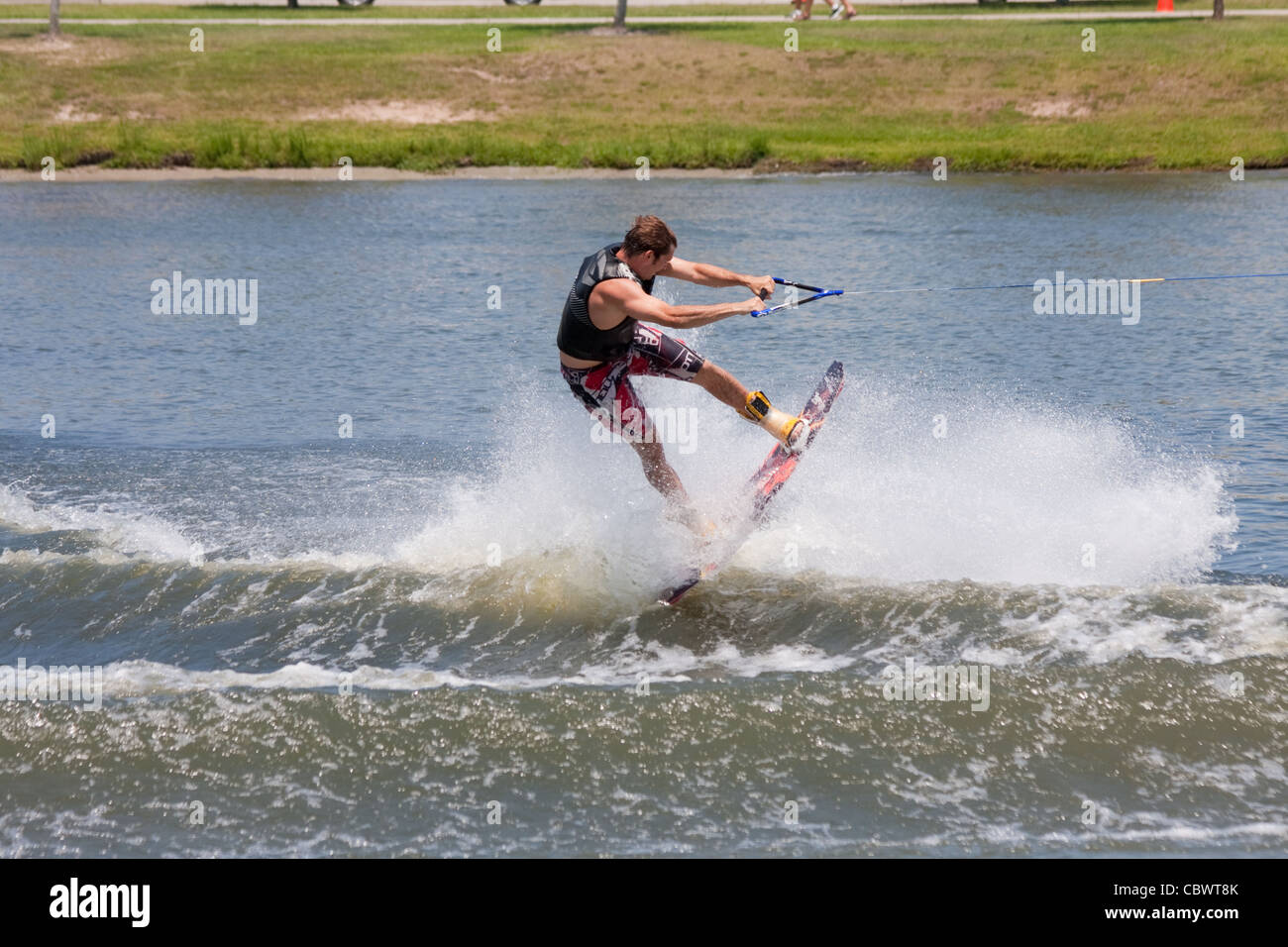 Man jumping the wake, stunts on a wakeboard, extreme sport Stock Photo ...
