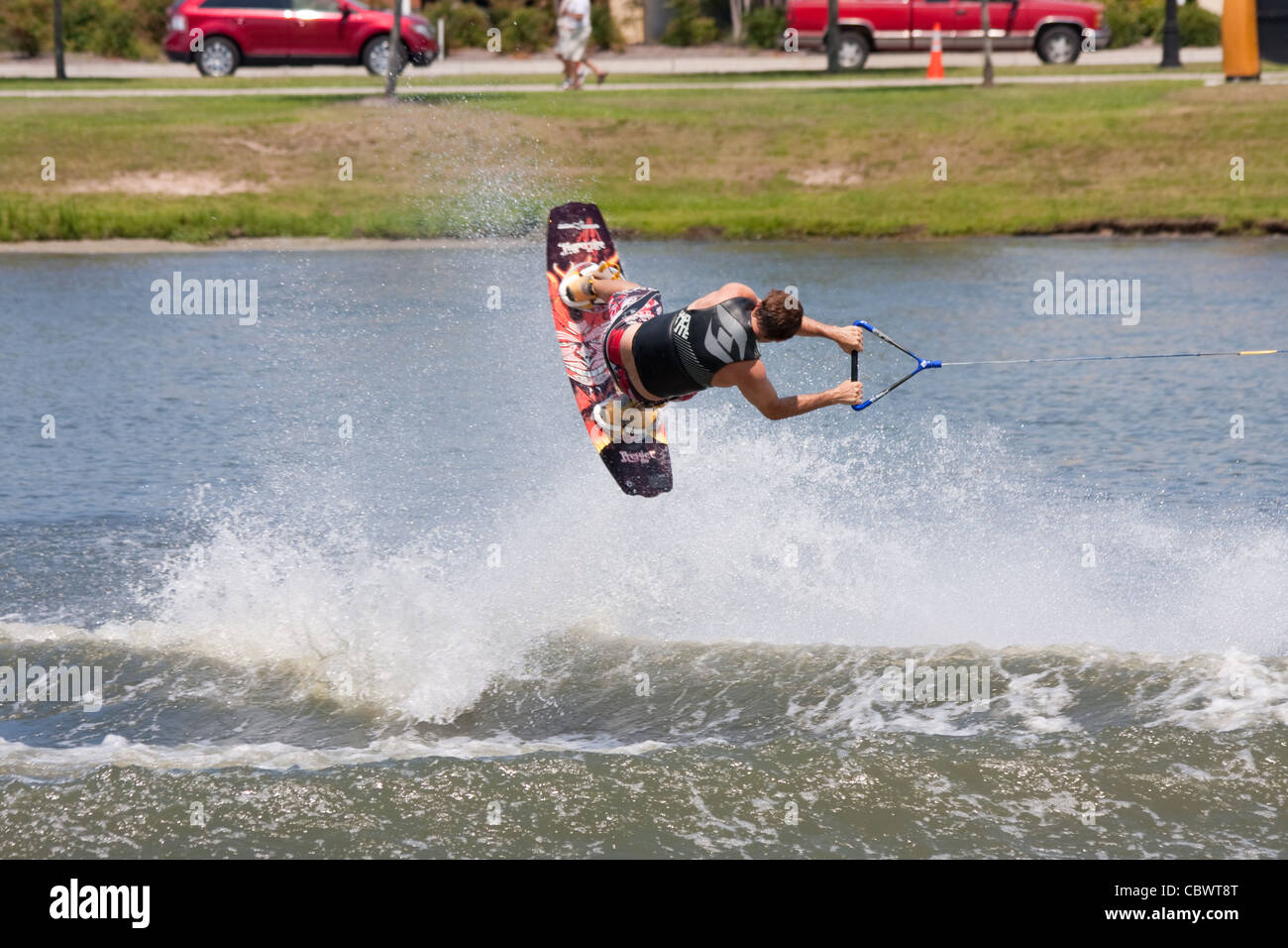 Man jumping the wake, stunts on a wakeboard, extreme sport Stock Photo ...