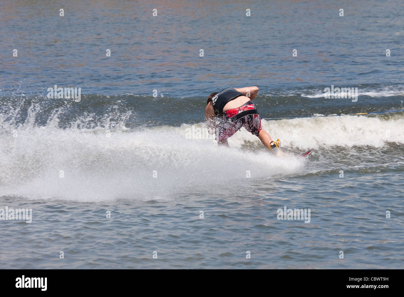 Man jumping the wake, stunts on a wakeboard, extreme sport Stock Photo ...