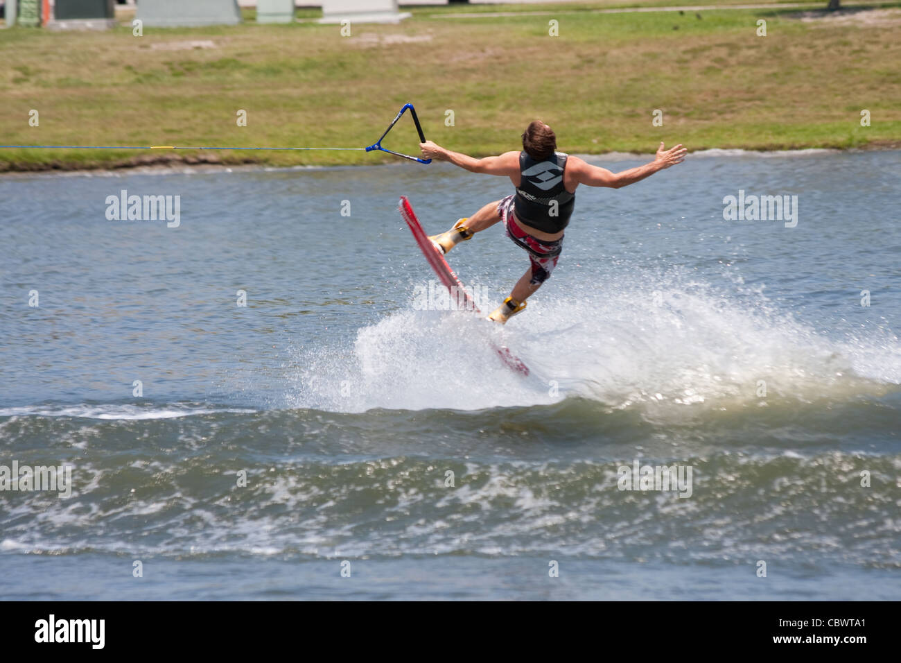 Man jumping the wake, stunts on a wakeboard, extreme sport Stock Photo ...