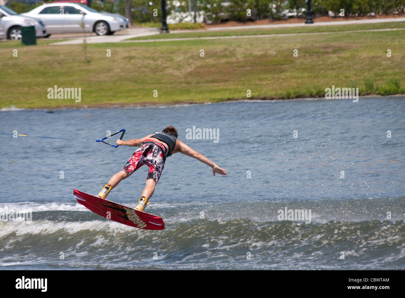 Man jumping the wake, stunts on a wakeboard, extreme sport Stock Photo ...