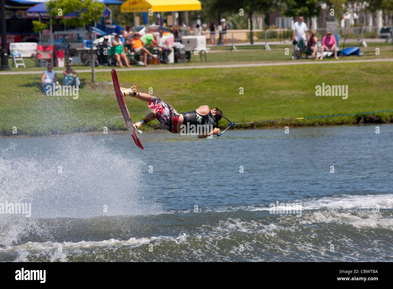 Man jumping the wake, stunts on a wakeboard, extreme sport Stock Photo ...