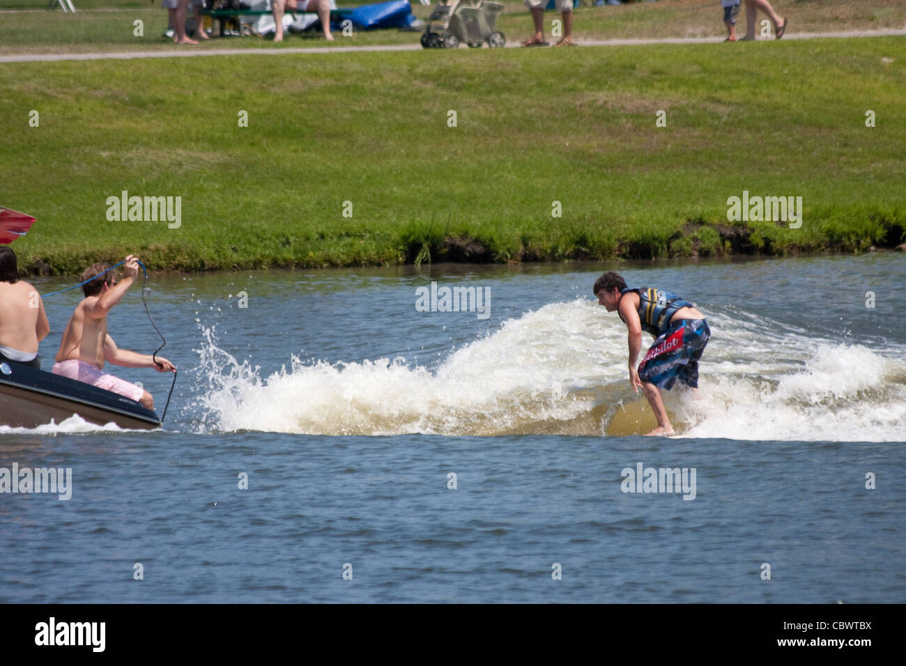 Man jumping the wake, stunts on a wakeboard, extreme sport Stock Photo ...