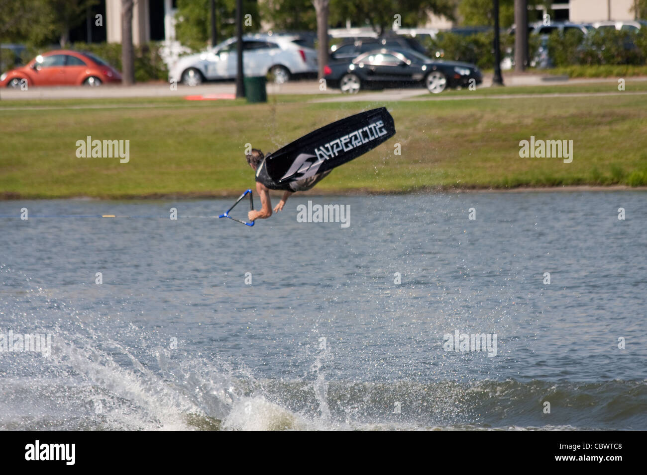 Man jumping the wake, stunts on a wakeboard, extreme sport Stock Photo ...