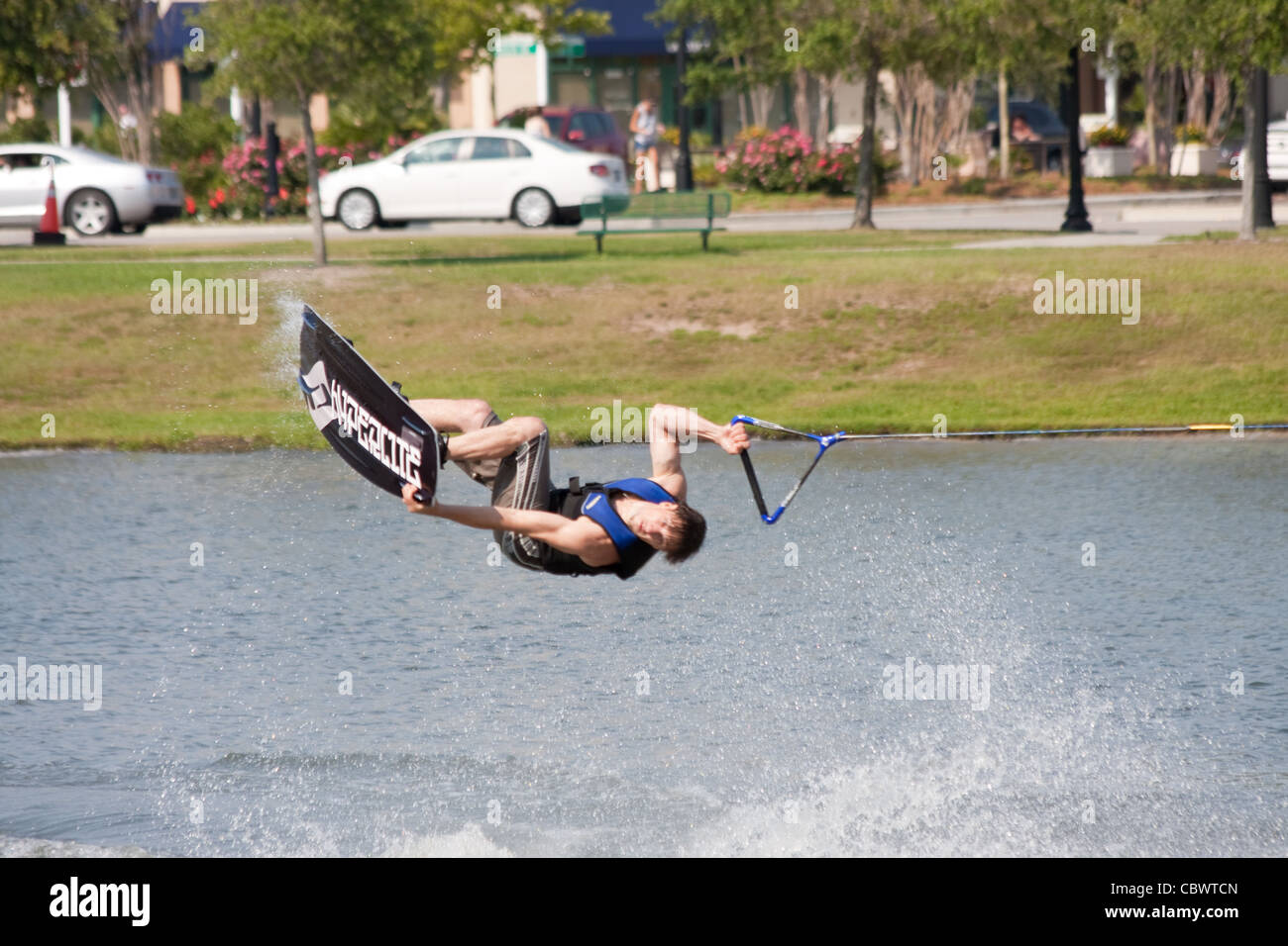 Man jumping the wake, stunts on a wakeboard, extreme sport Stock Photo ...
