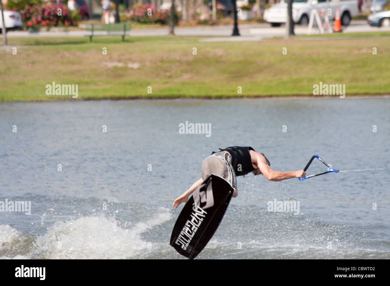 Man jumping the wake, stunts on a wakeboard, extreme sport Stock Photo ...