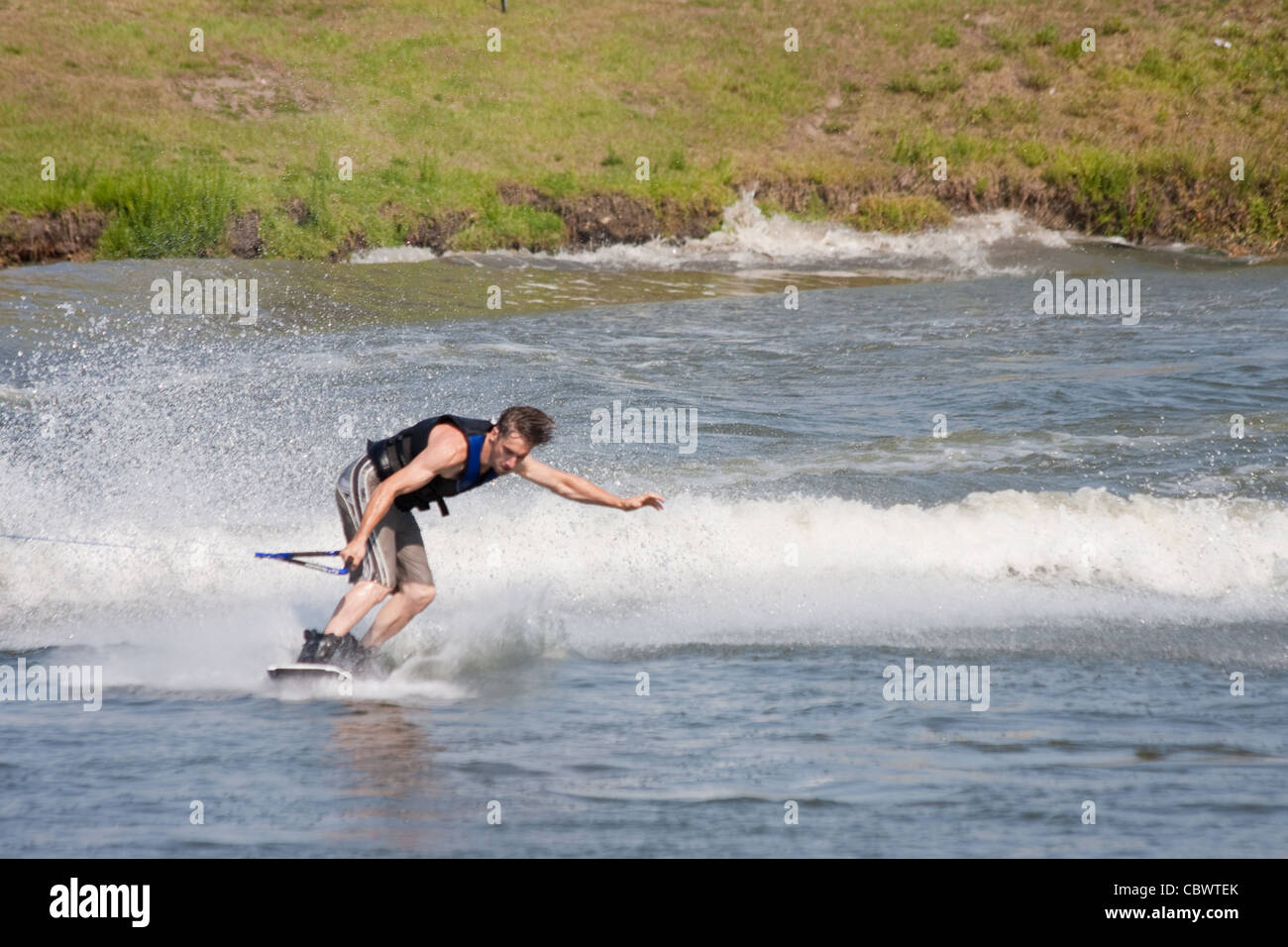 Man jumping the wake, stunts on a wakeboard, extreme sport Stock Photo ...