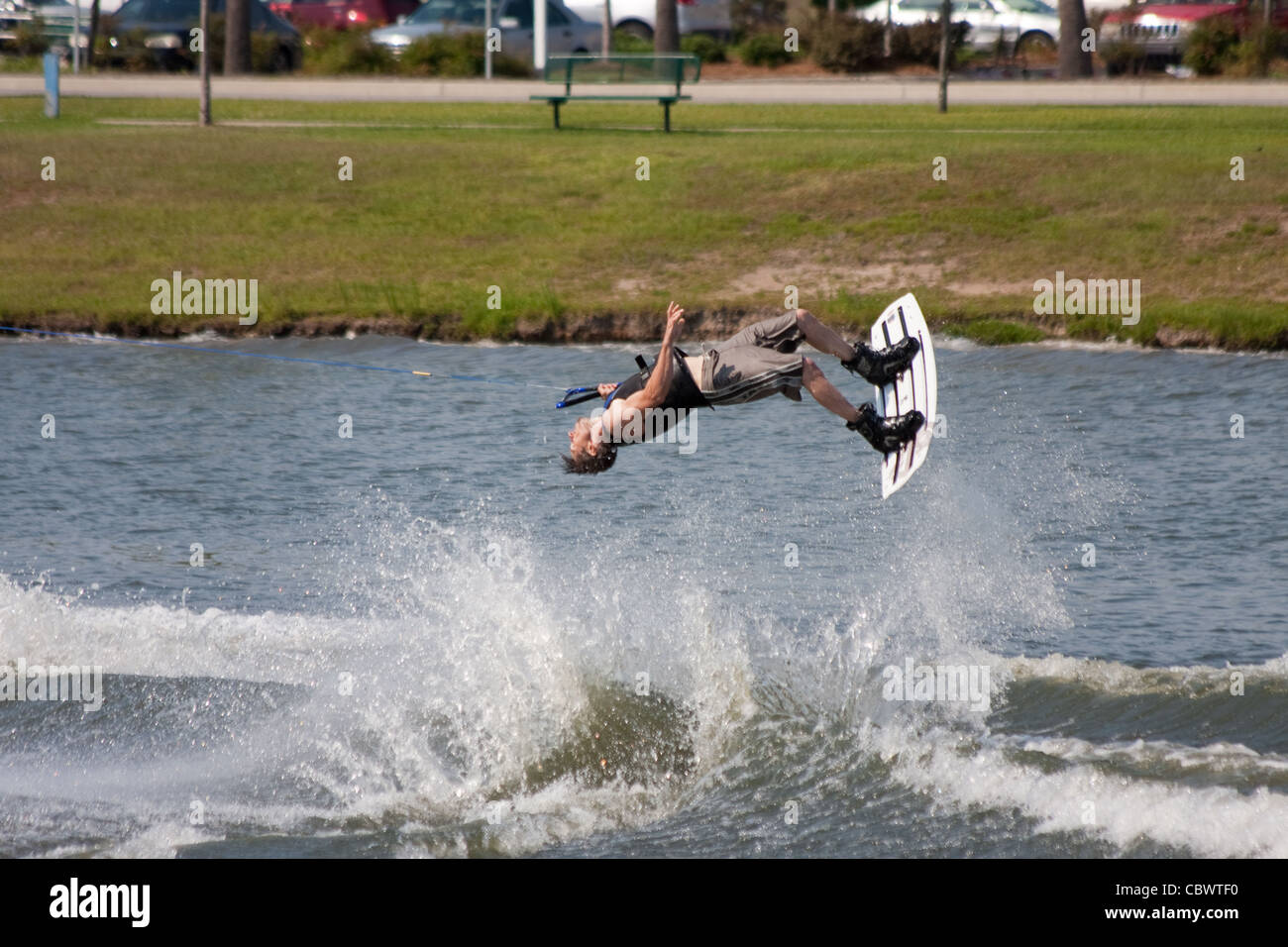 Man jumping the wake, stunts on a wakeboard, extreme sport Stock Photo ...
