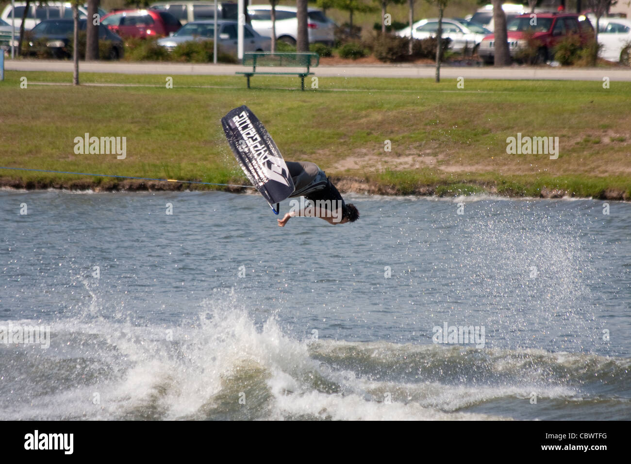 Man jumping the wake, stunts on a wakeboard, extreme sport Stock Photo ...