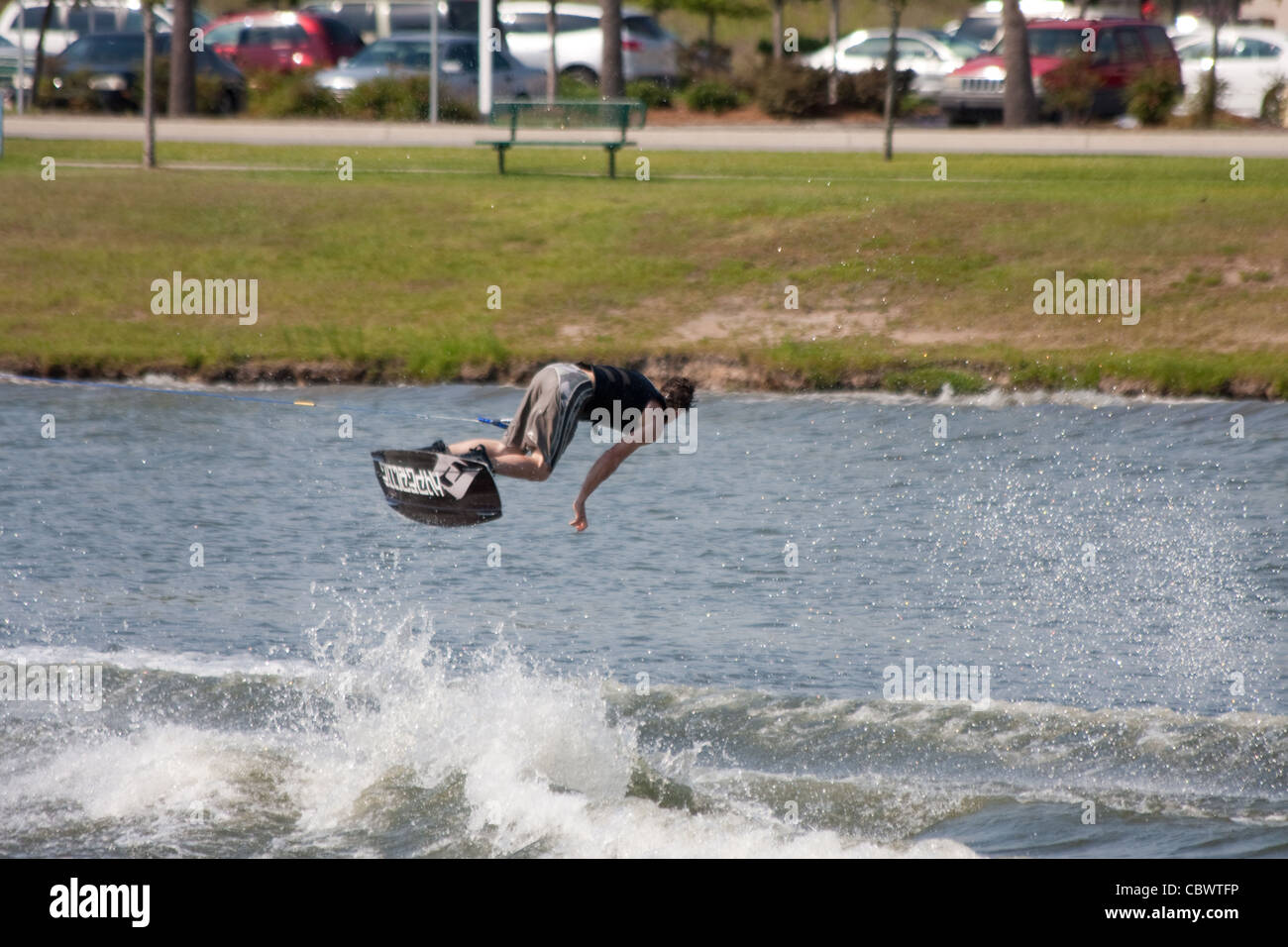 Man jumping the wake, stunts on a wakeboard, extreme sport Stock Photo ...