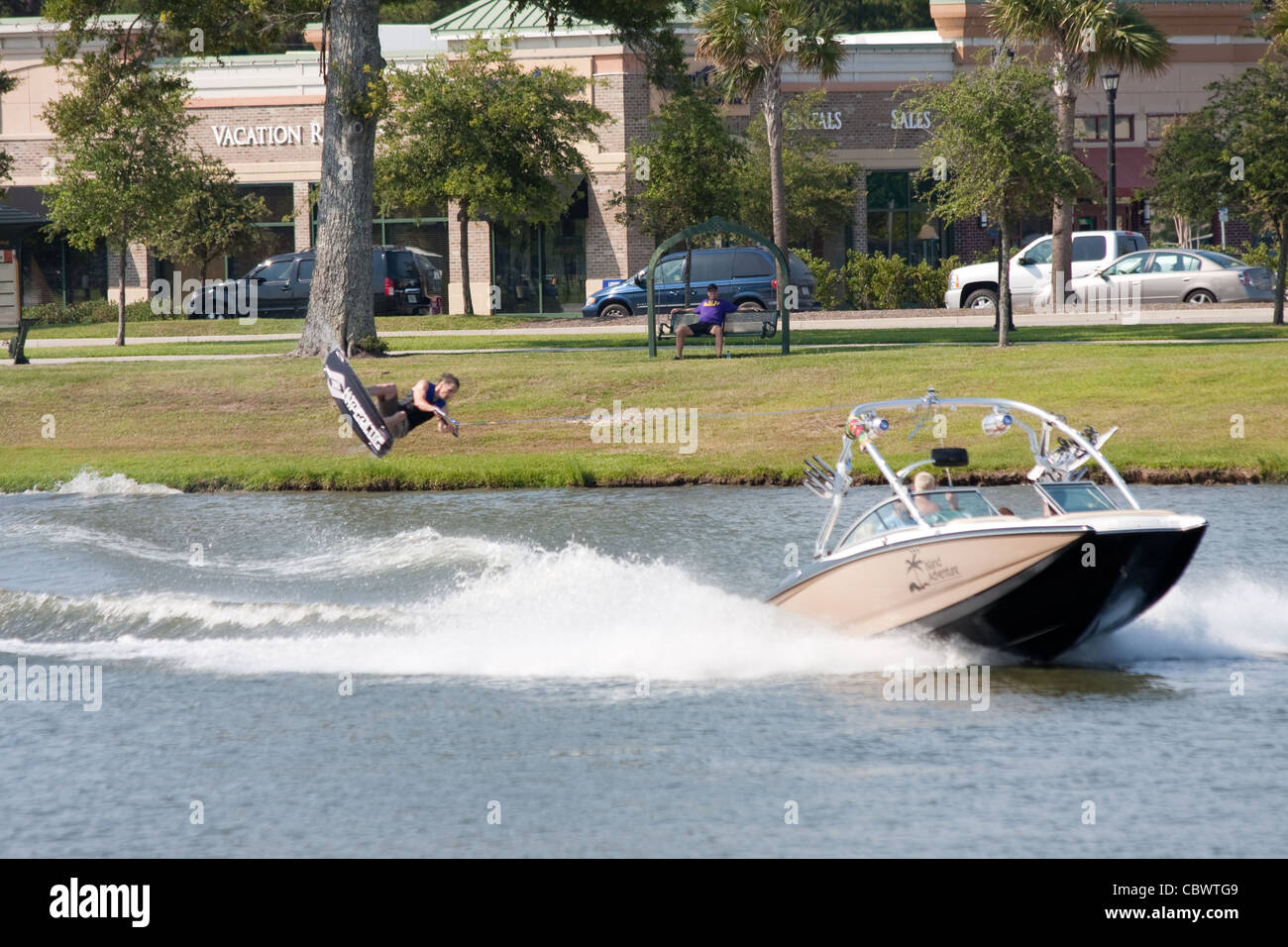 Man jumping the wake, stunts on a wakeboard, extreme sport Stock Photo ...