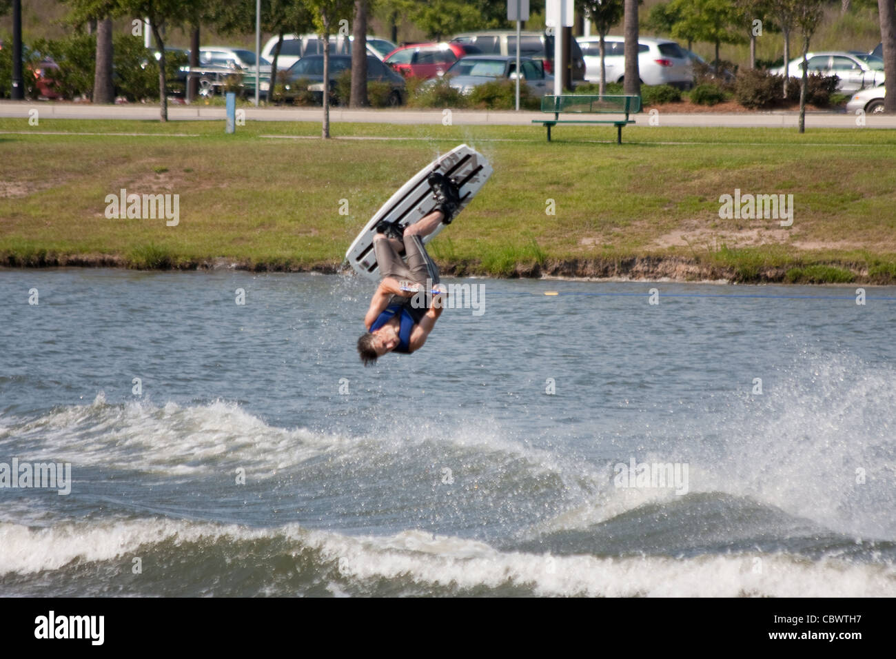 Man jumping the wake, stunts on a wakeboard, extreme sport Stock Photo ...