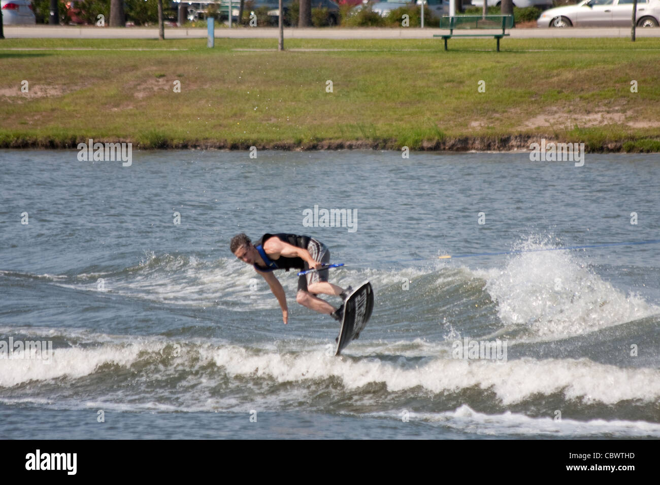 Man jumping the wake, stunts on a wakeboard, extreme sport Stock Photo ...