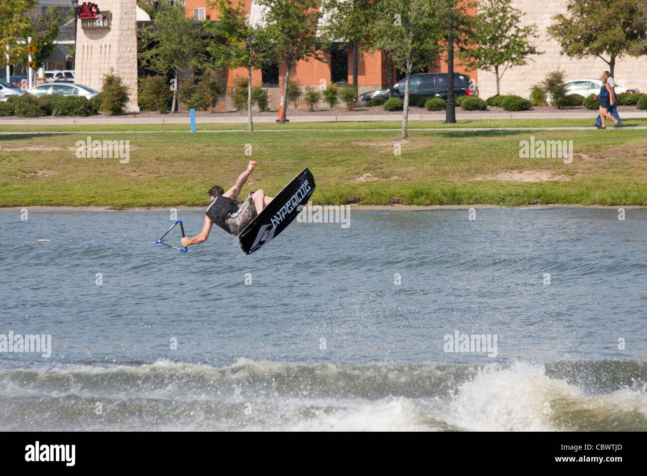 Man jumping the wake, stunts on a wakeboard, extreme sport Stock Photo ...