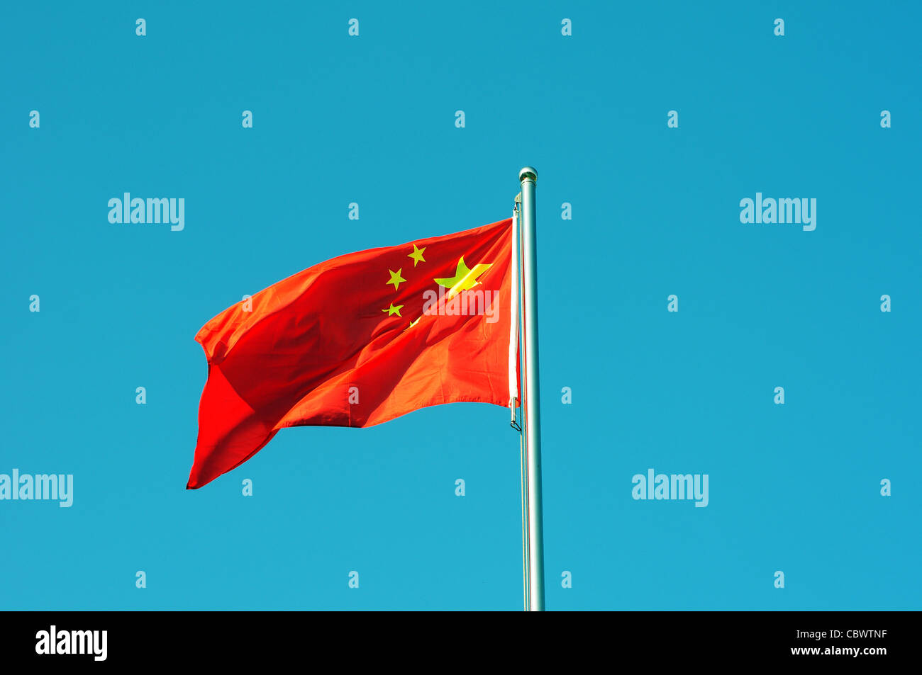 Chinese national five-star red flag fluttering in the wind against blue ...