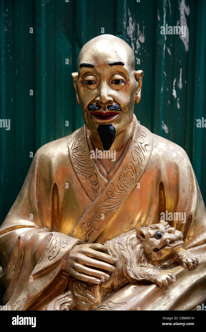 Gold painted Buddha holding a tiger Ten Thousand Buddhas Monastery ...