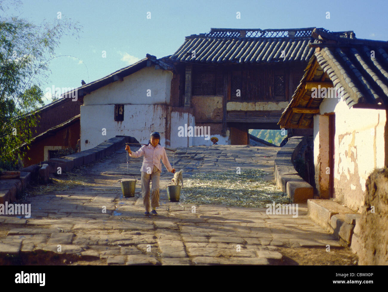 Woman carrying pales rural village Yunnan China Stock Photo - Alamy