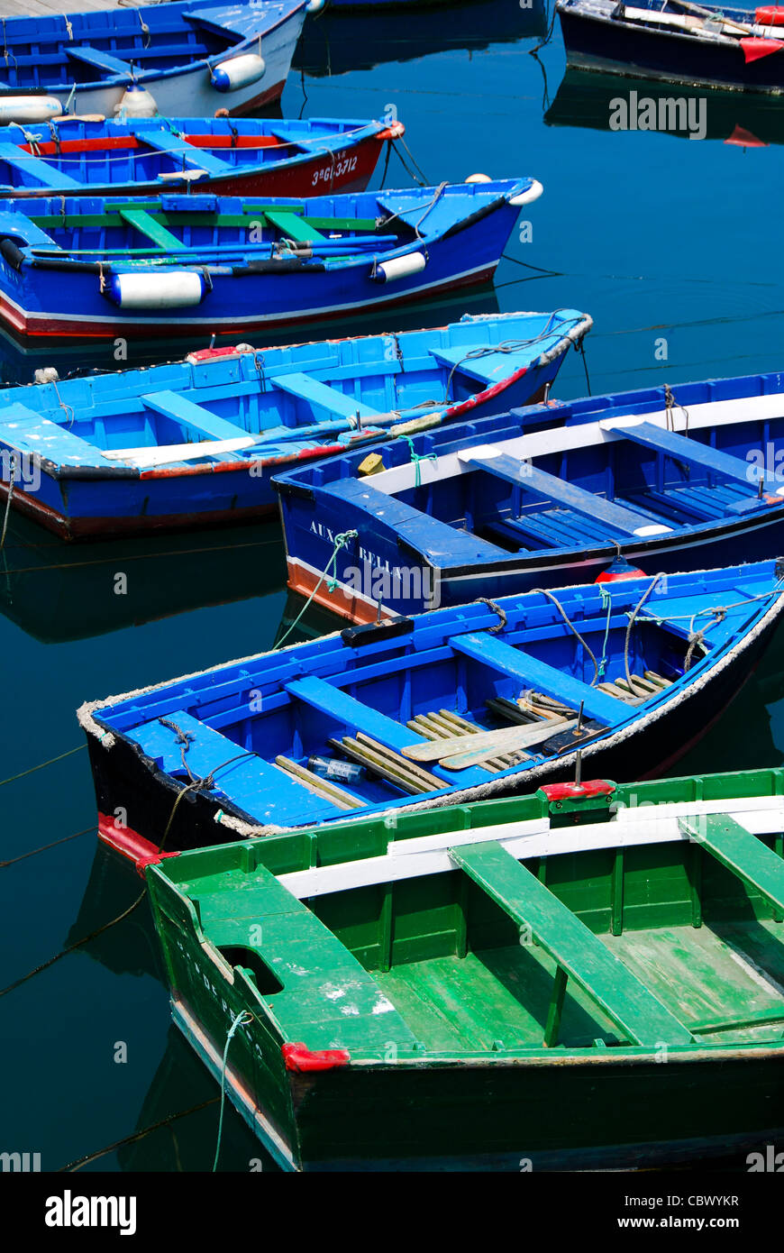 coloured rowing boats in the harbour of Cudillero, Asturia, Spain Stock ...
