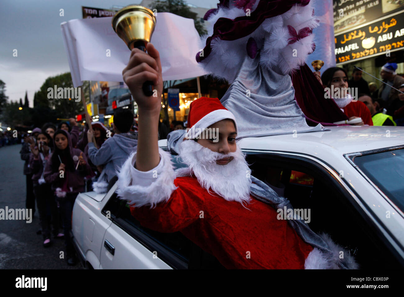 An Arab Christian dressed as Santa Claus take part in the traditional ...