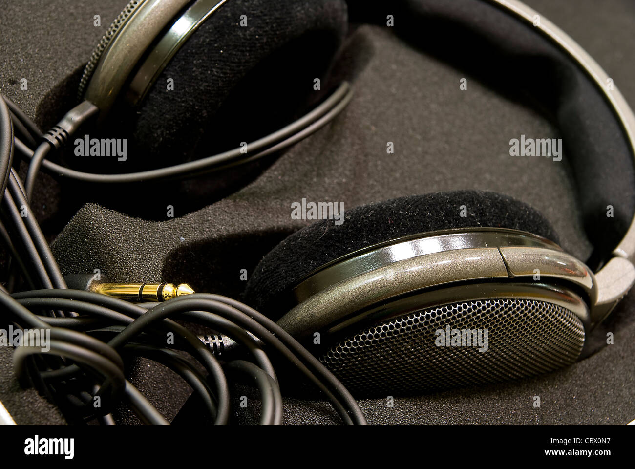 Headphones laying in a black case Stock Photo - Alamy