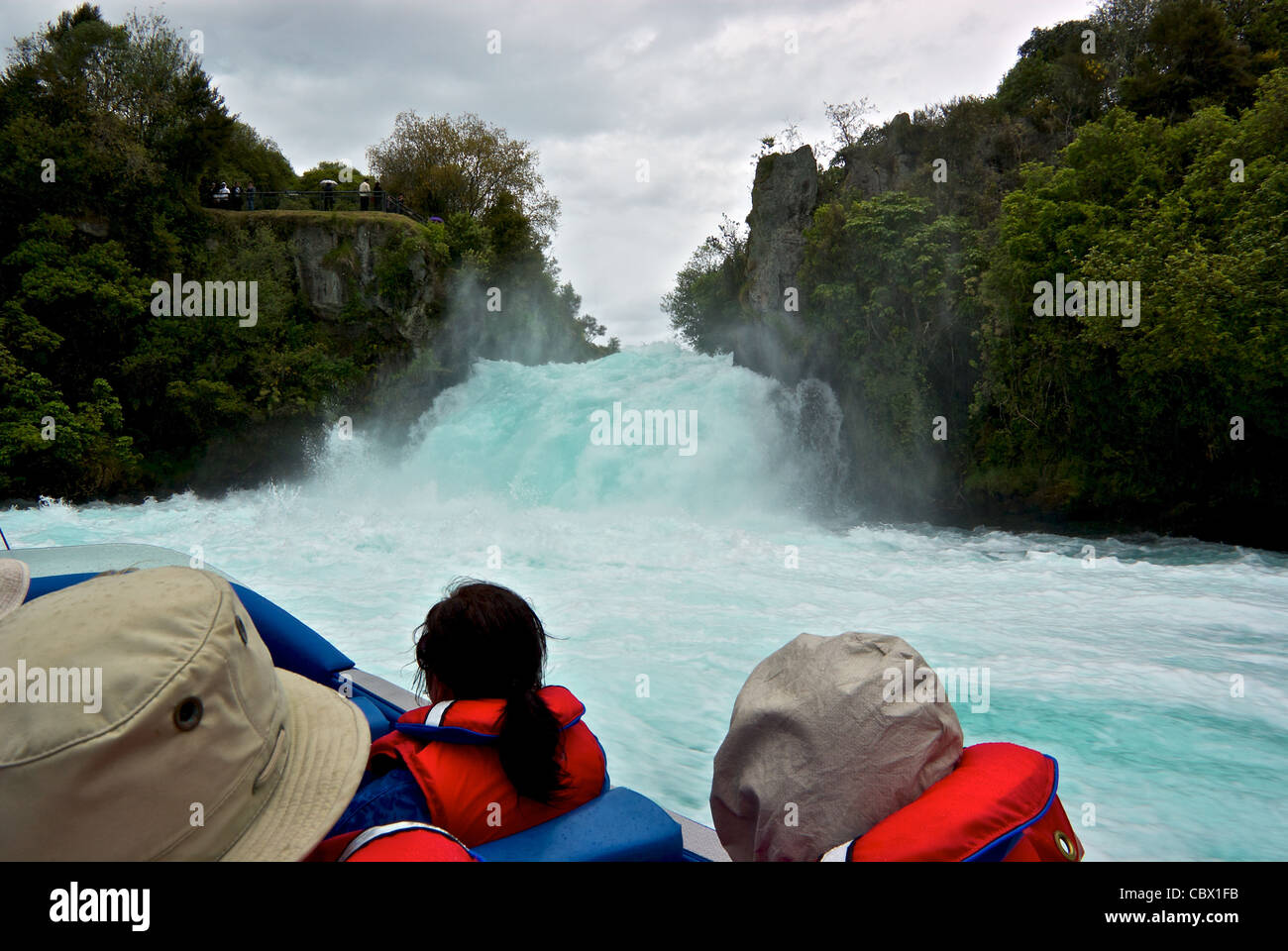 Tourists on jet boat tour to turbulent misty torrent of water at Huka ...