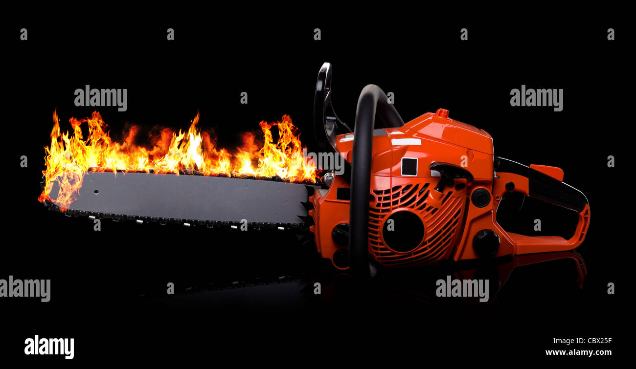 Red chainsaw in fire isolated on black Stock Photo - Alamy