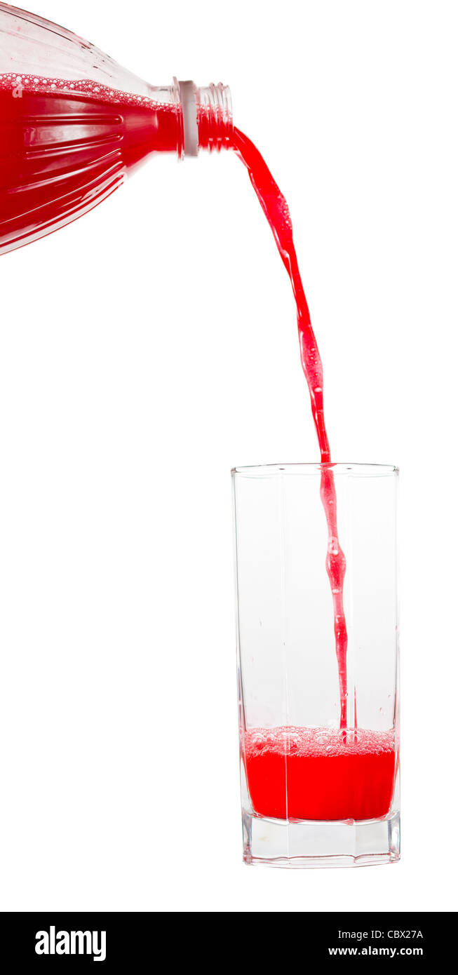 Red juice being poured into a glass on white background Stock Photo - Alamy