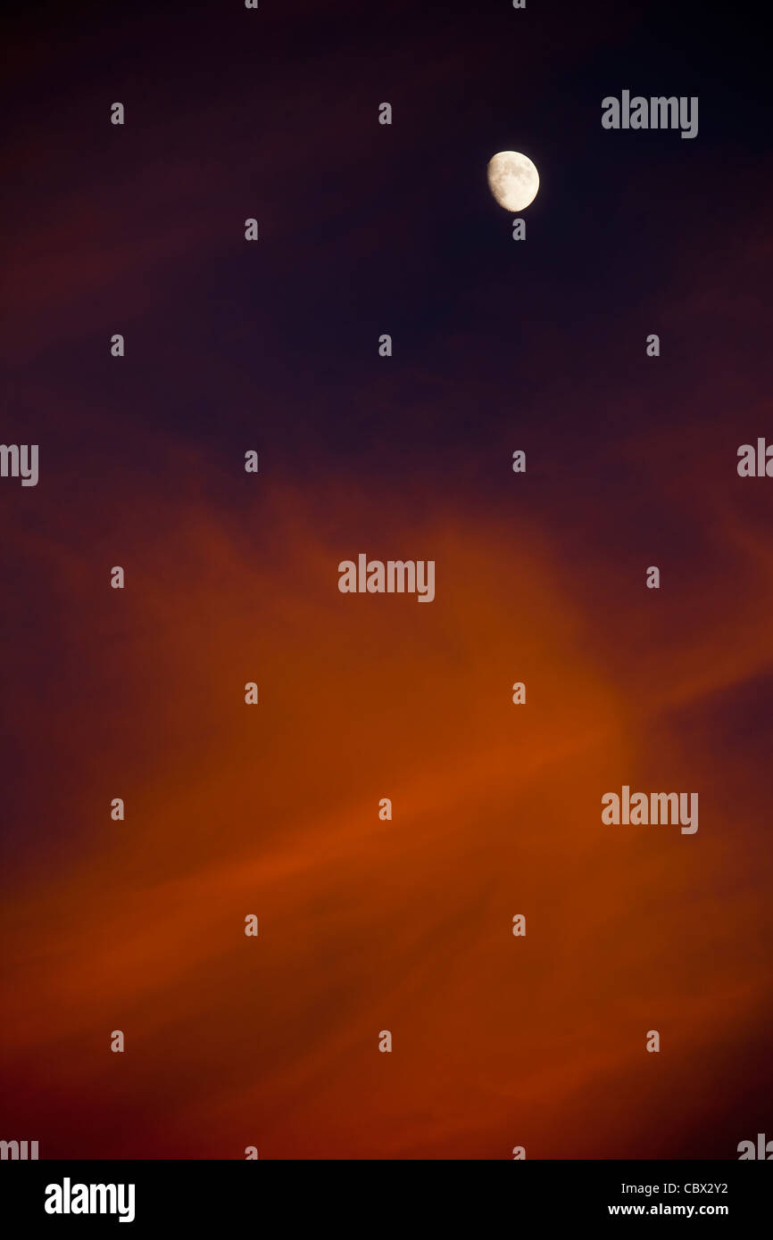 Sunset with moon and clouds of orange color Stock Photo - Alamy
