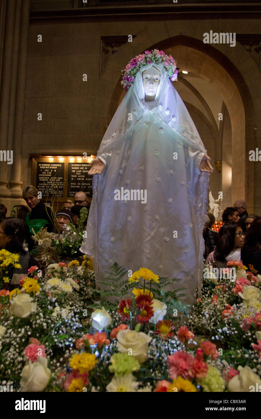 A Filipino Simbang Gabi procession carrying a statue of Our Lady of ...