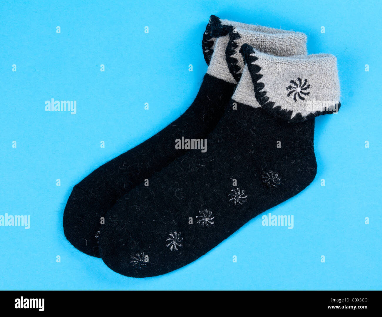 a pair of wool socks on a blue background Stock Photo - Alamy