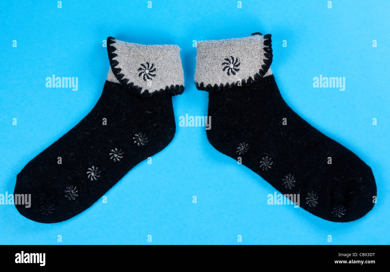 a pair of wool socks on a blue background Stock Photo - Alamy