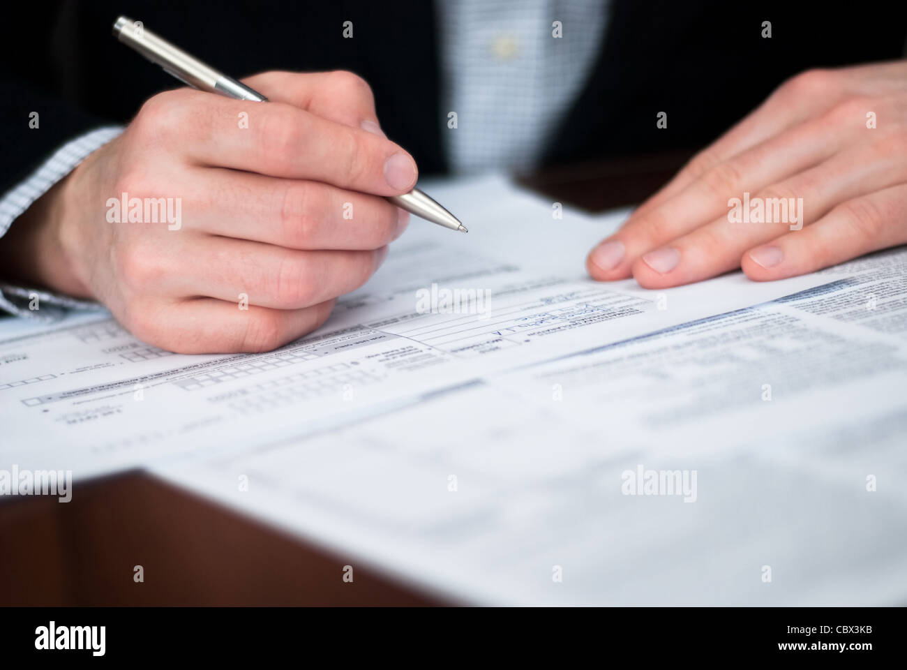 Businessman Filling Out Form Desk High Resolution Stock Photography and ...
