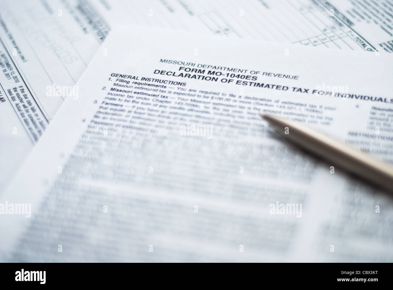 Filling out business documents on a desk Stock Photo - Alamy